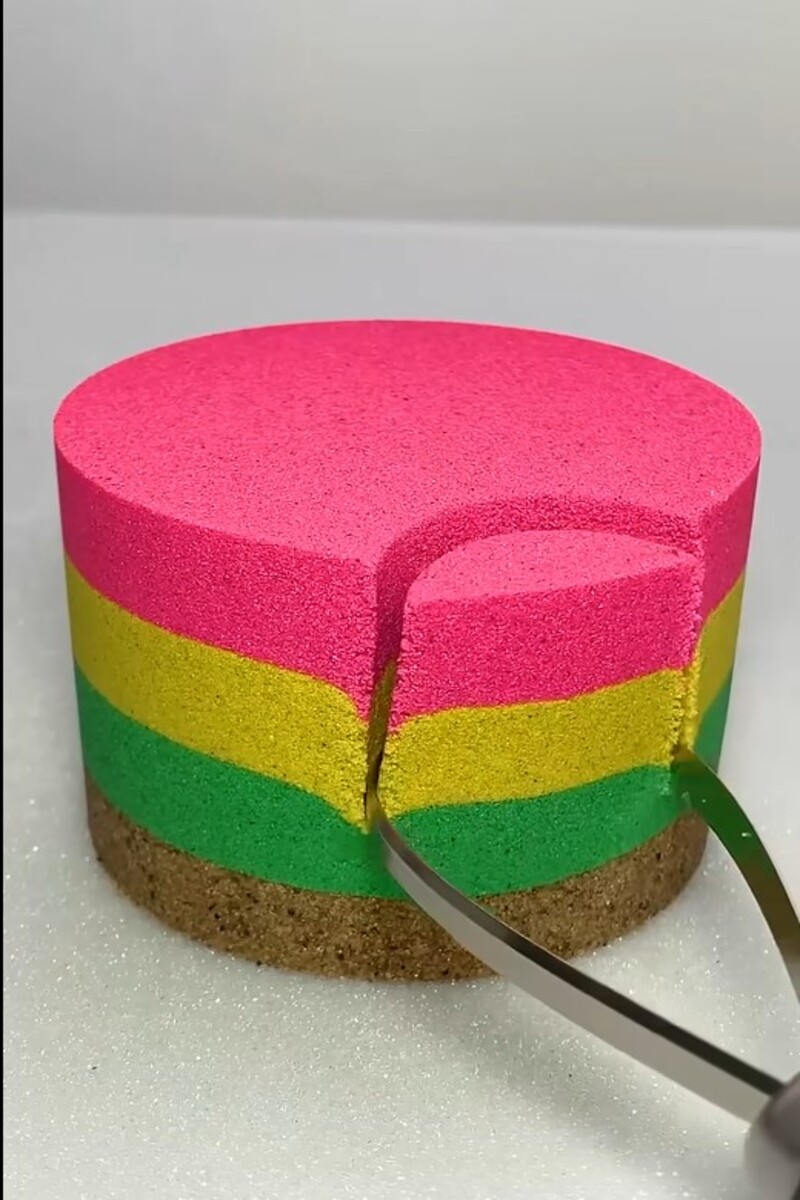 Smooth cut through layered kinetic sand cake