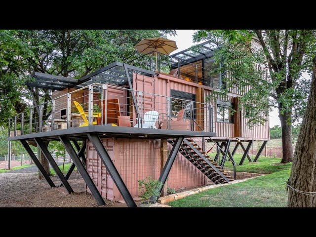 Beautiful shipping container house raised among the tree canopies
