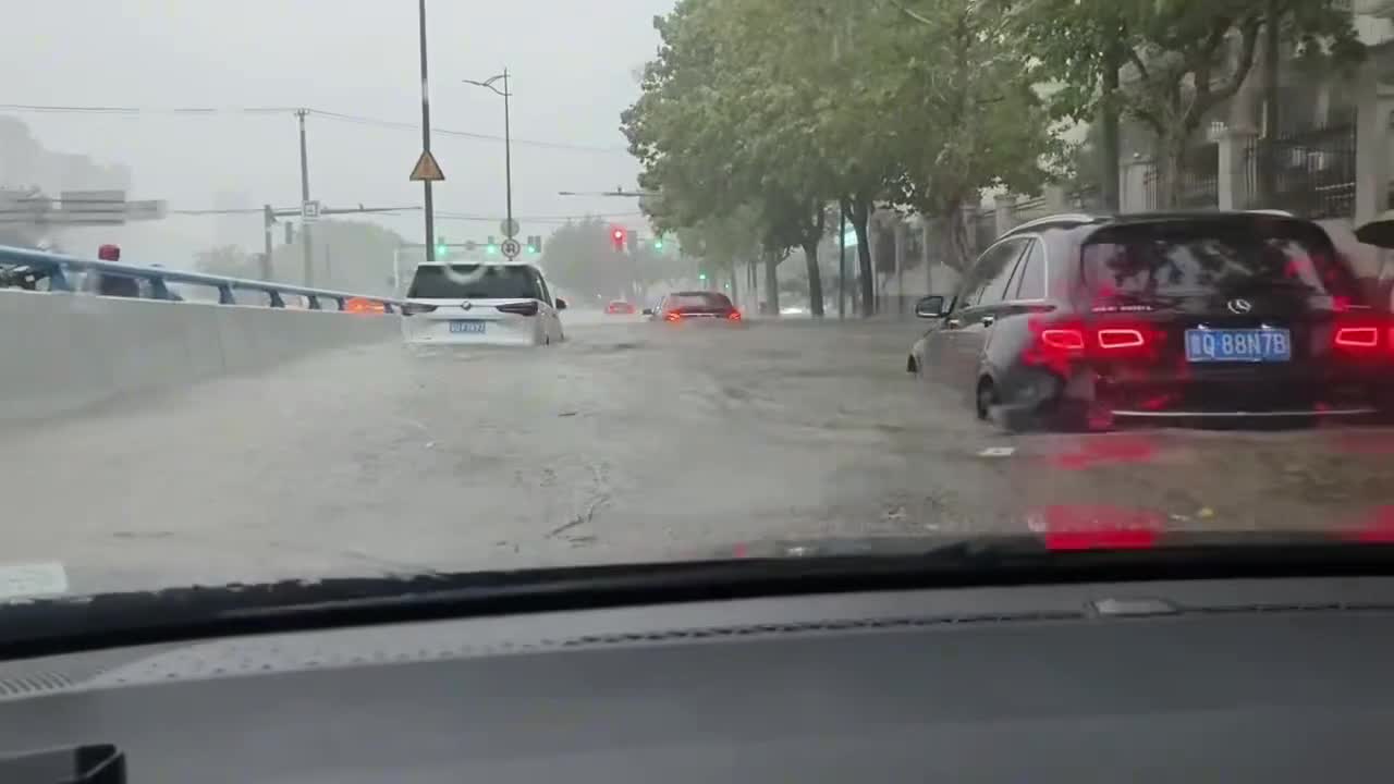 Cars struggle through flooded highway after heavy rain in Shanghai, China