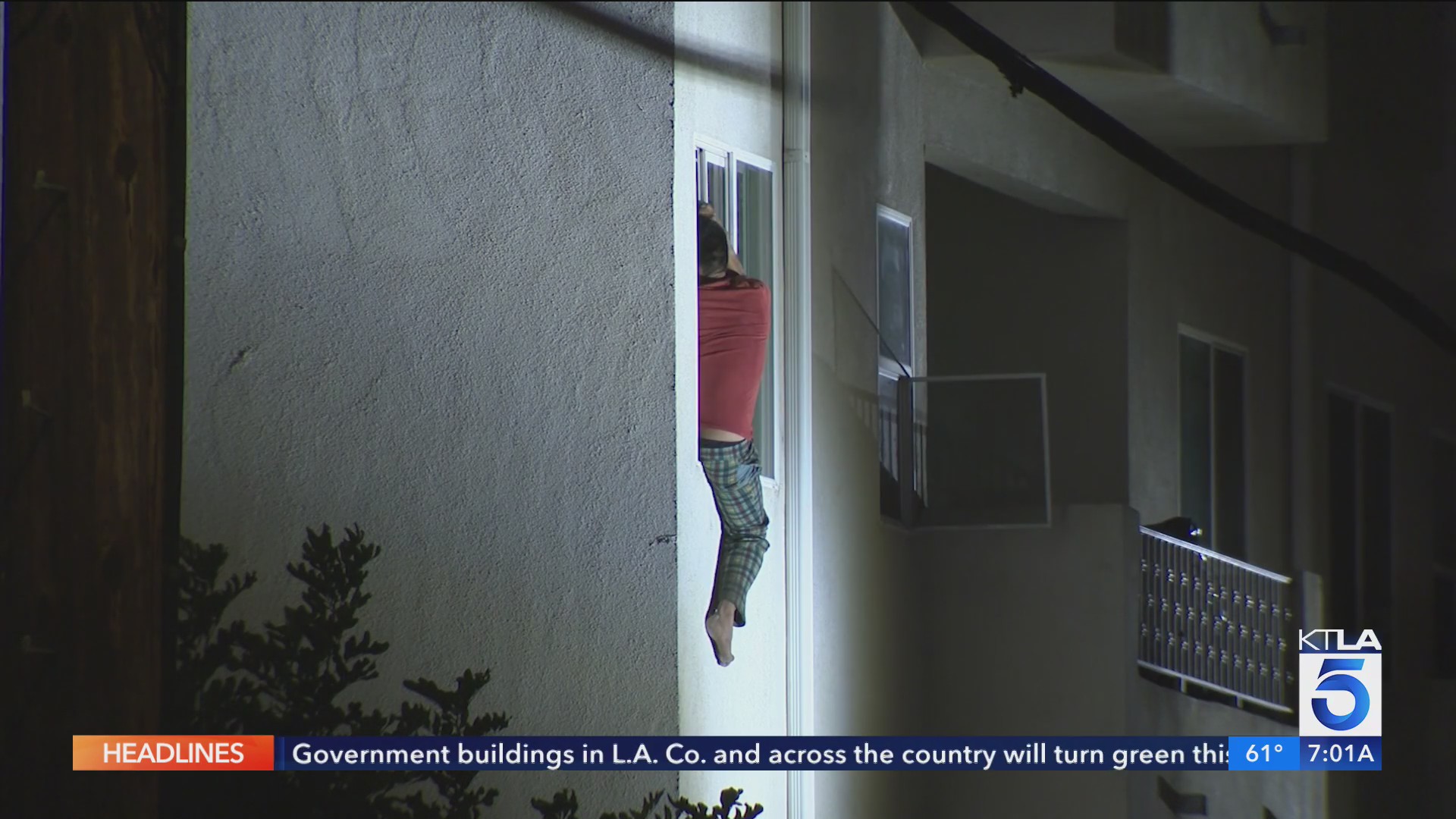 Man throwing items in L.A. apartment building hangs out of window