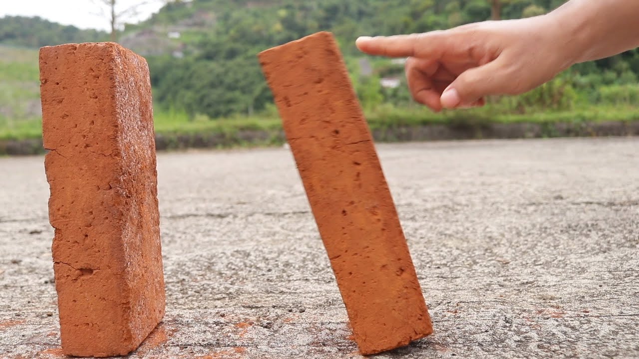 Epic brick dominoes: Watch a giant outdoor chain reaction in action!