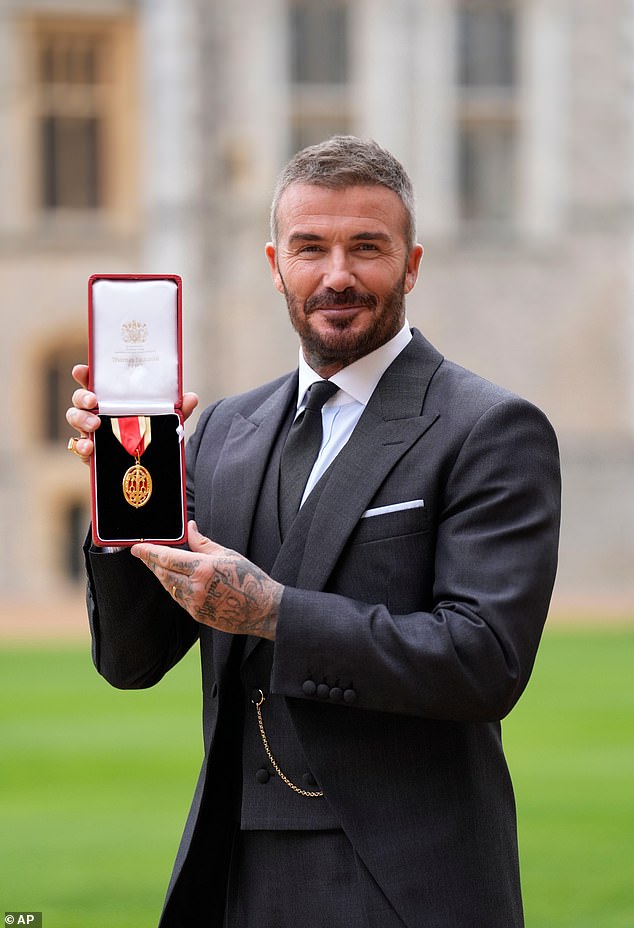Sir David Beckham runs for cover as firework explodes in front of him