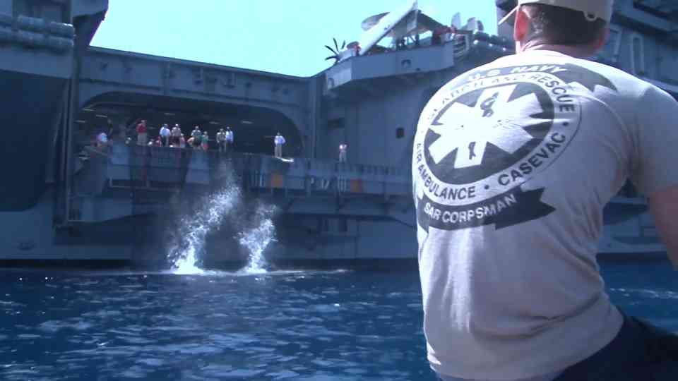US sailors jump off an aircraft carrier