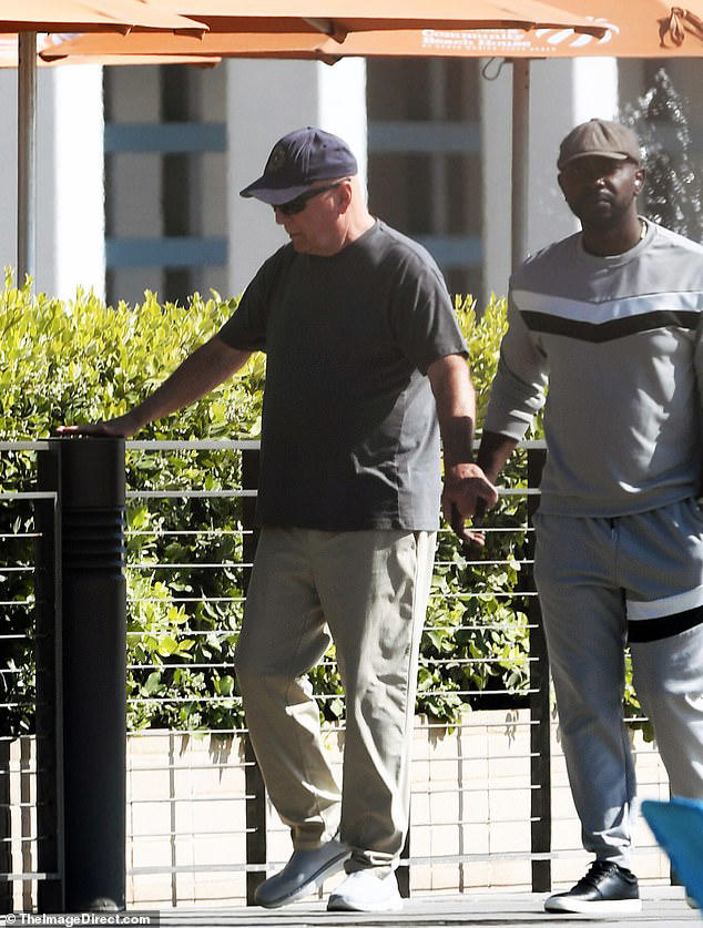 Dementia-stricken Bruce Willis, 70, holds carer's hand on very rare ...