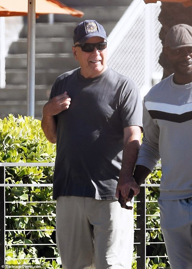 Dementia-stricken Bruce Willis, 70, holds carer's hand on very rare ...