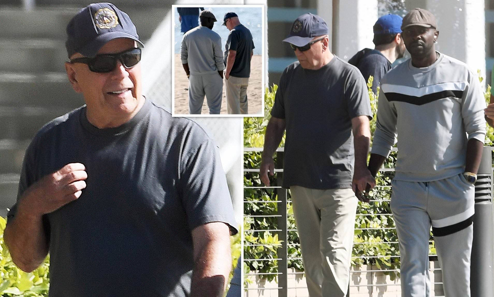 Dementia-stricken Bruce Willis, 70, holds carer's hand on very rare ...