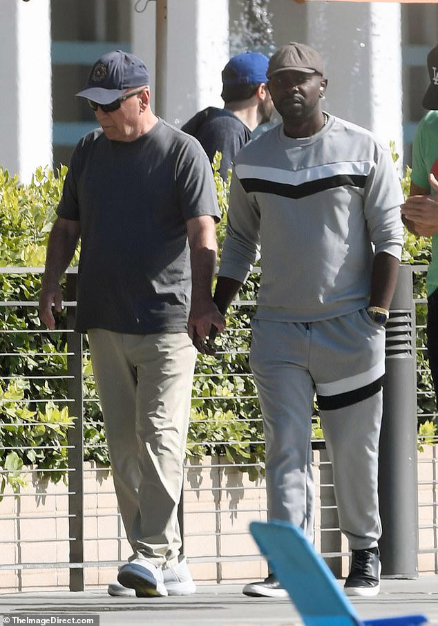Dementia-stricken Bruce Willis, 70, holds carer's hand on very rare ...