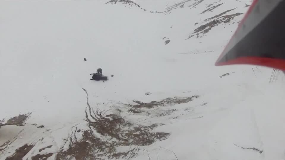 Vintage Snowmobile Rolls down Snowy Hill