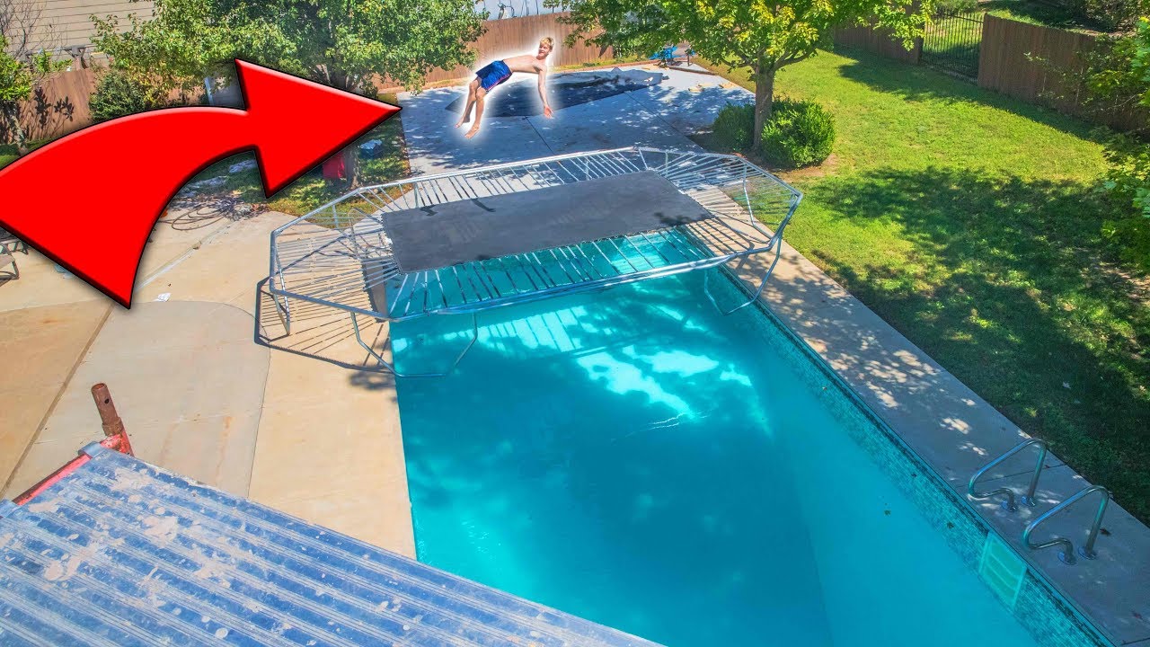 A truly outrageous trampoline setup over a pool
