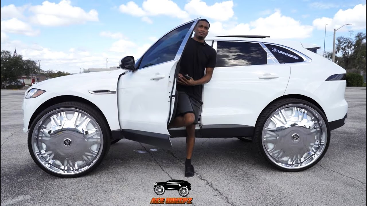Str8PressueAudio's white Jaguar F-Pace on 32" DUB floaters