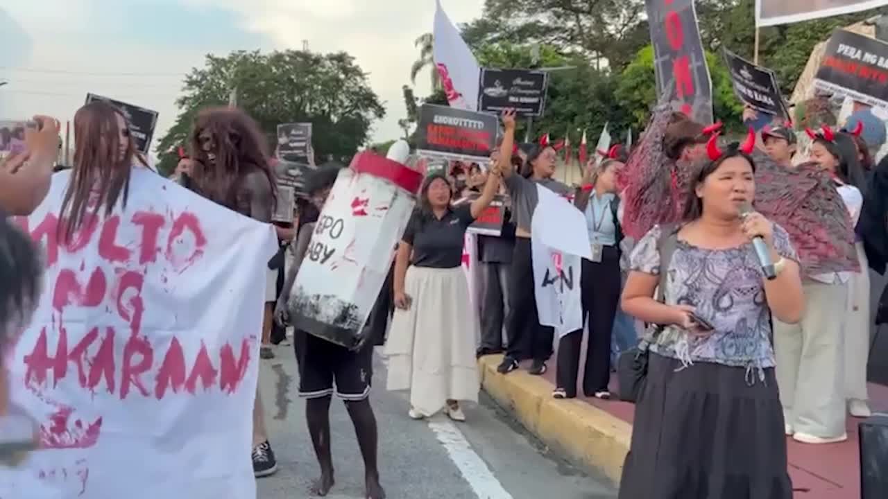 Youths wear Halloween costumes at anti-corruption rally