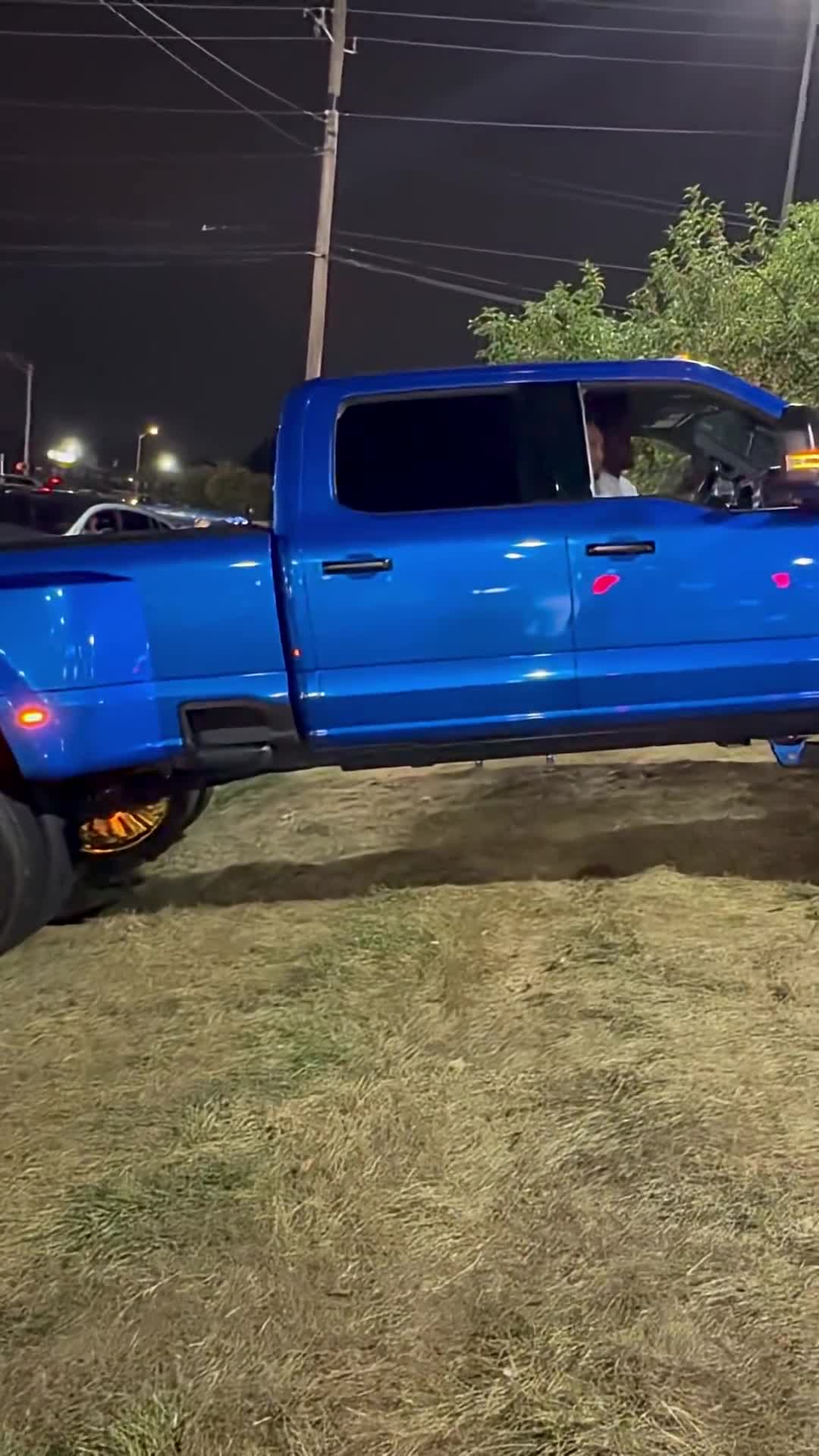 Blue Ford dually truck on gold 30’s riding