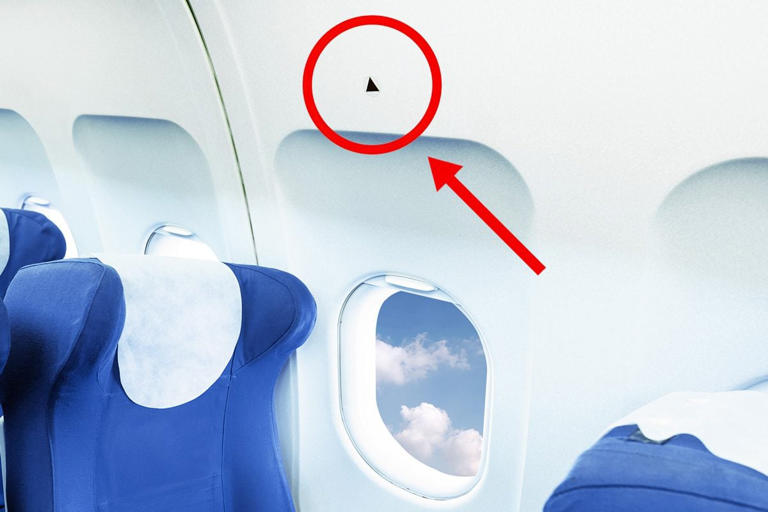Here’s what that tiny black triangle above airplane windows means