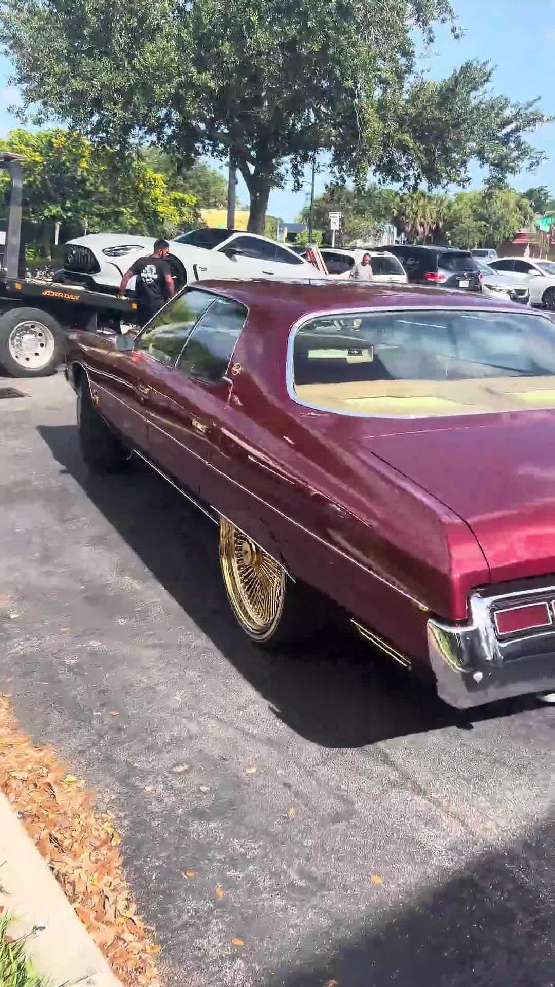 4-door Chevy donk on gold 24’s Daytons riding out
