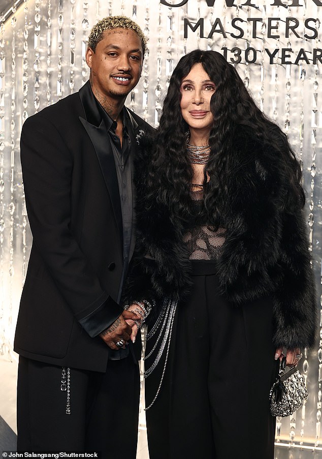 Cher, 79, and toyboy Alexander 'AE' Edwards, 39, hold hands on red carpet