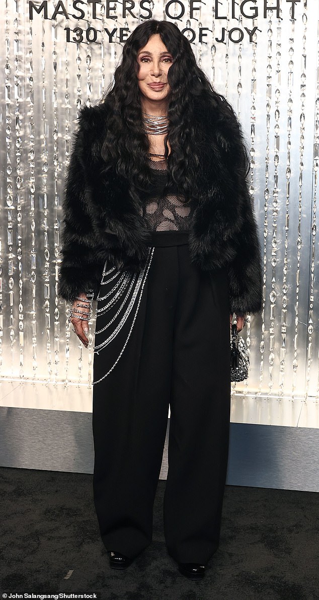 Cher, 79, and toyboy Alexander 'AE' Edwards, 39, hold hands on red carpet