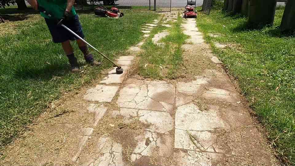 Neglected entryway uncovered after years of lawn encroachment