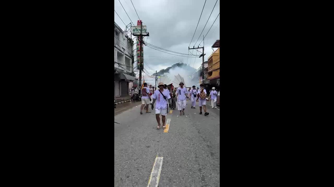 Devotee has cheeks pierced with bamboo poles at vegetarian festival in ...