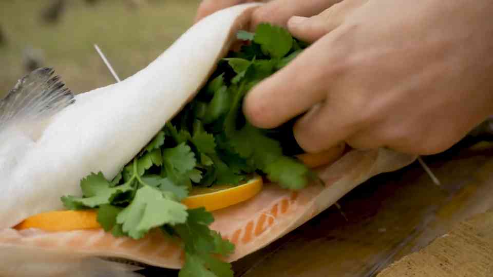 Whole Atlantic salmon cooked to perfection on a spit