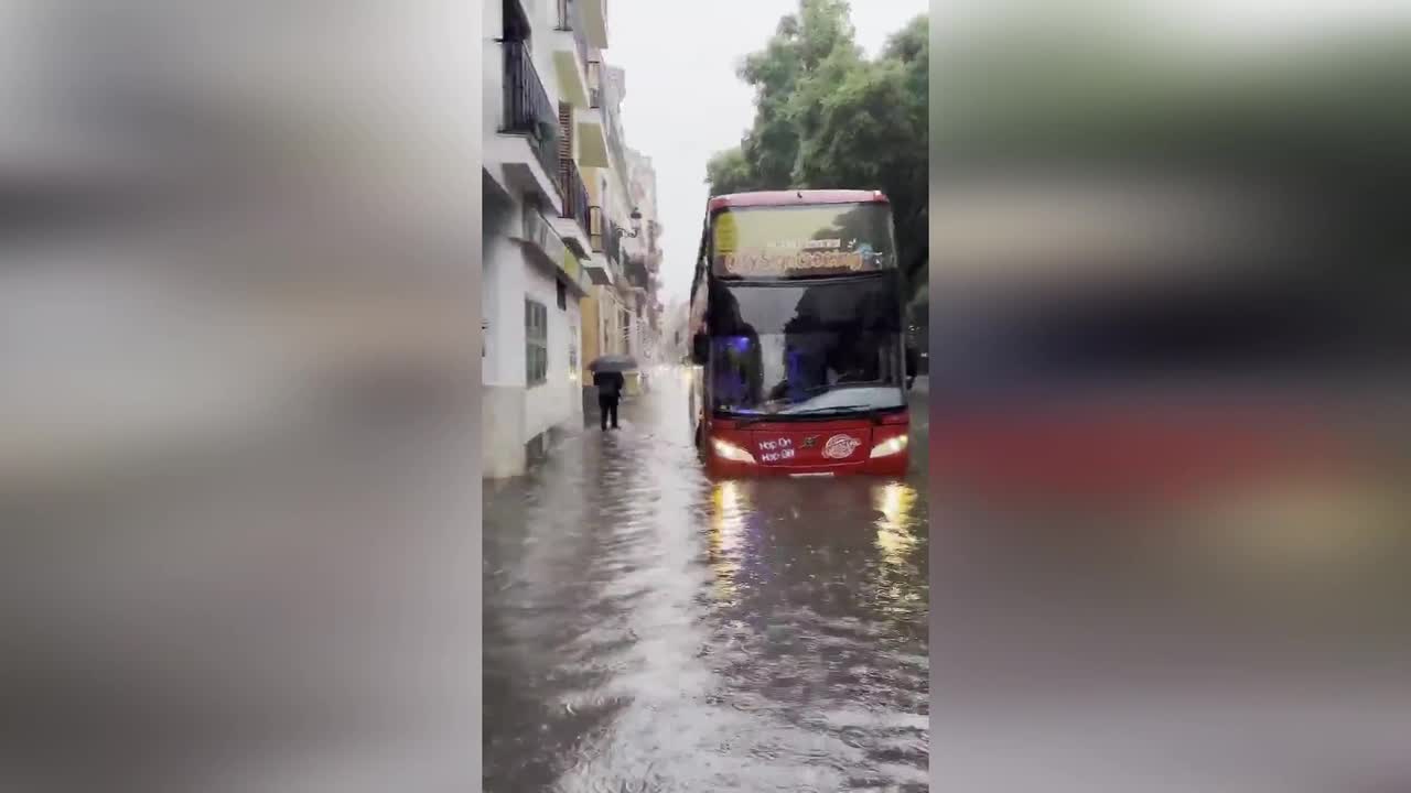 Red Tourist Bus Battles Torrents As Seville Streets Flood