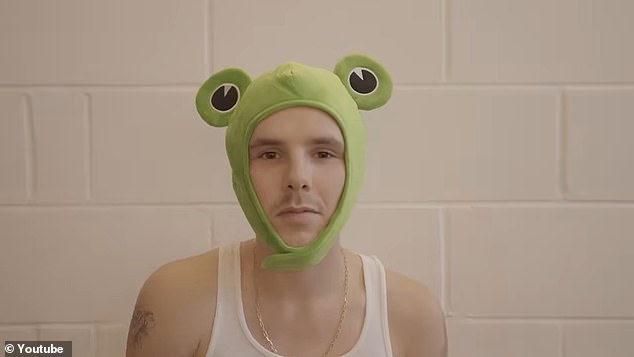 Cruz Beckham strips off into a vest and a quirky frog hat as he ...