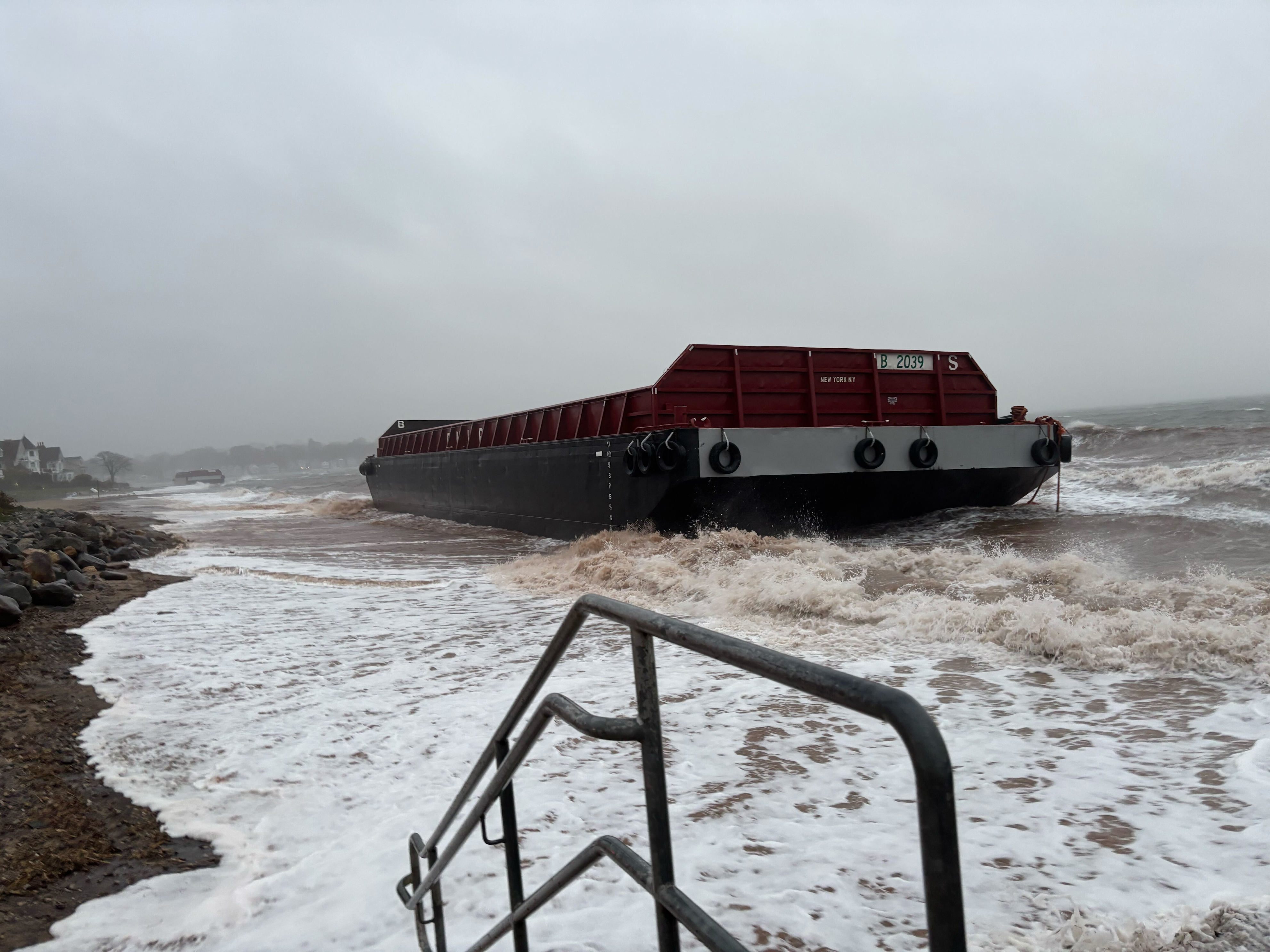 Barges run ashore on Woodmont Beach in Milford, Conn.
