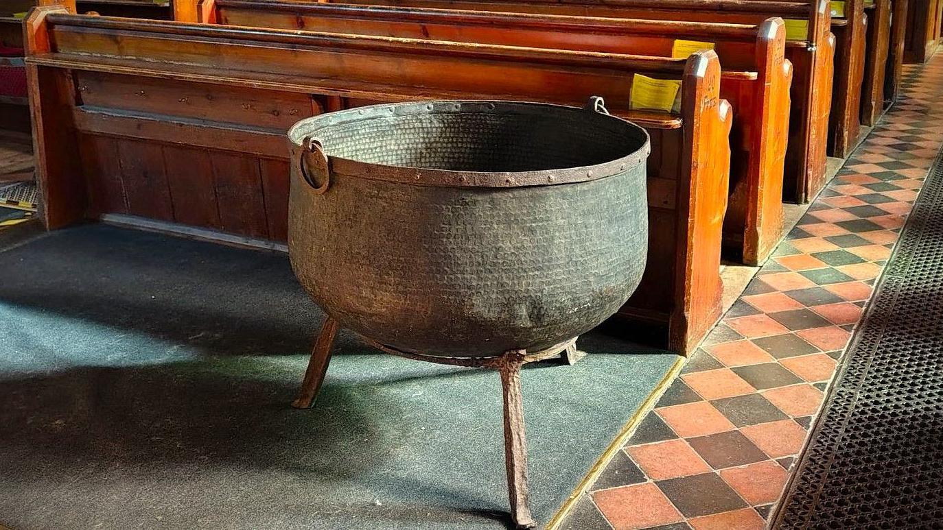 How did a witch's cauldron end up in a church?