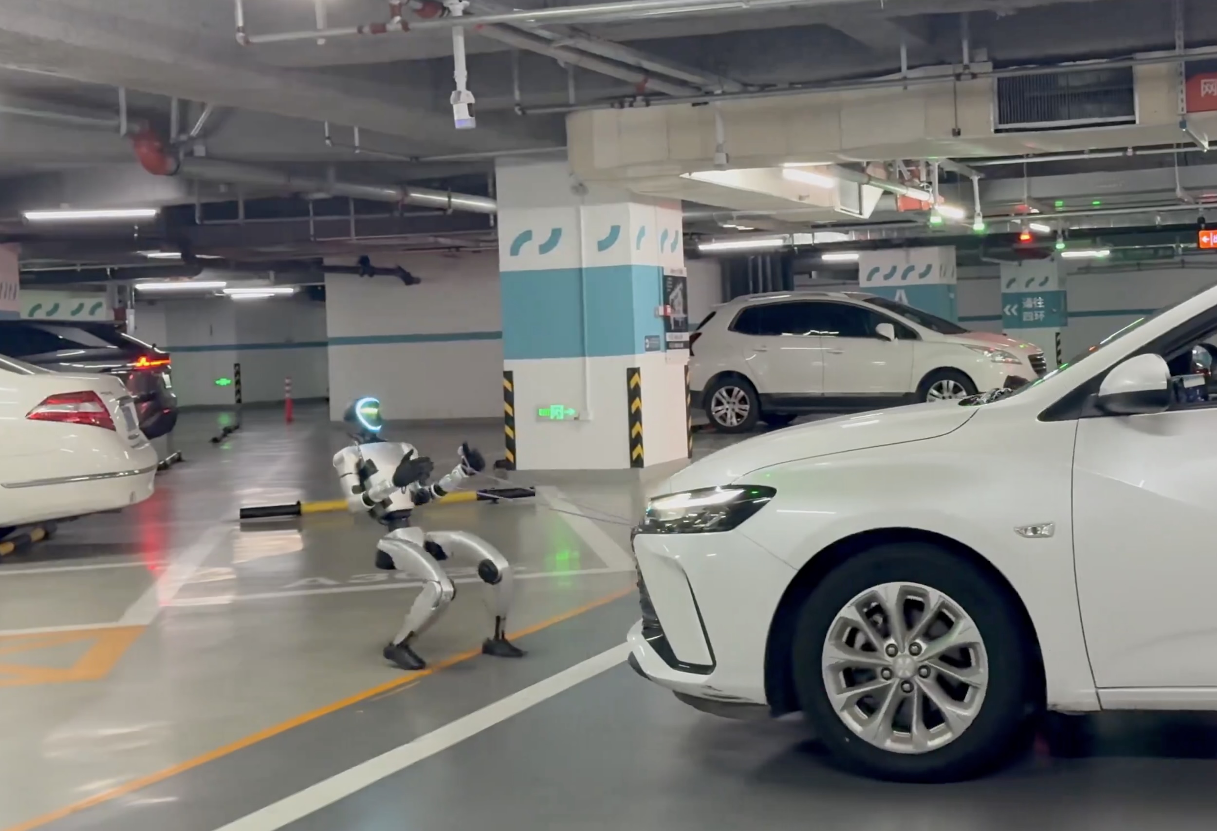 Watch this little humanoid robot pull a car with ease