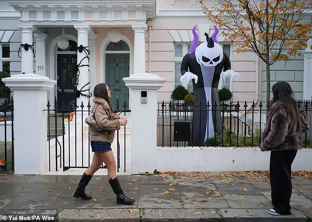 Halloween havoc: Skeletons, coffins and ghouls decorate some of London ...