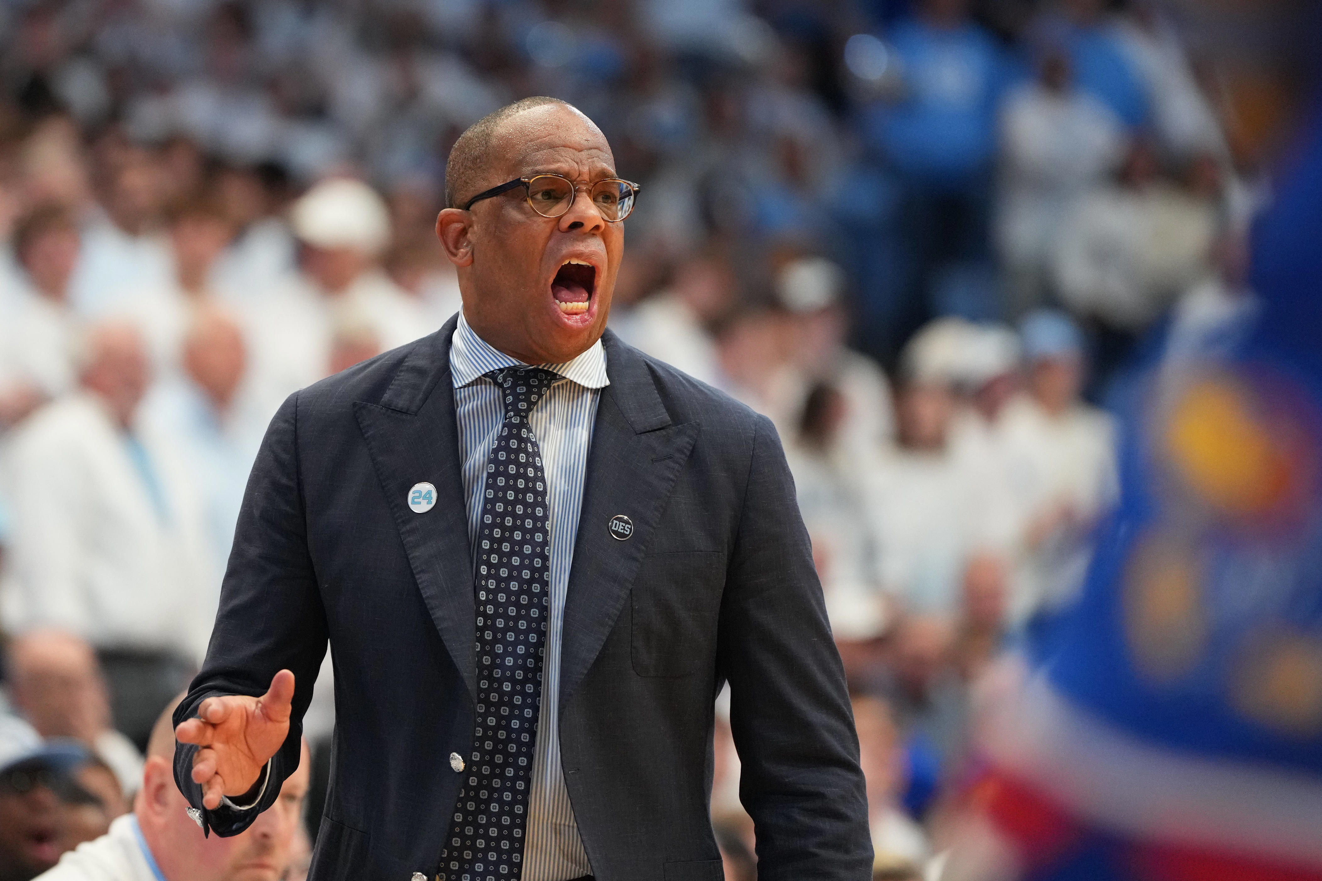 Hubert Davis celebrates with Roy Williams after Kansas win