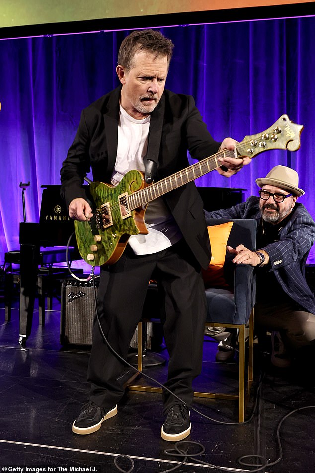 Michael J Fox rocks out to a Back To The Future-style performance at ...