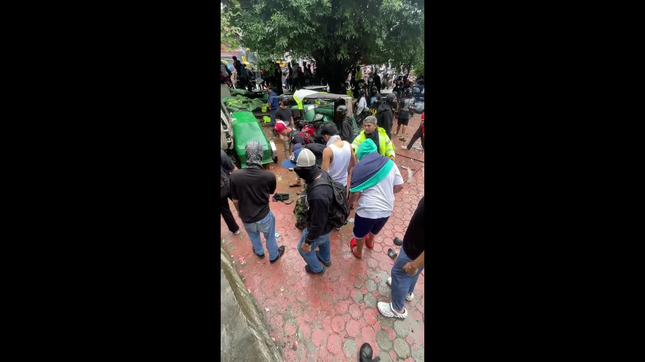 Anti-corruption protesters throw police equipment into water