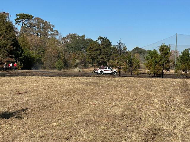 Lawn mower sparks small brush fire behind Waffle House on Ledo Road
