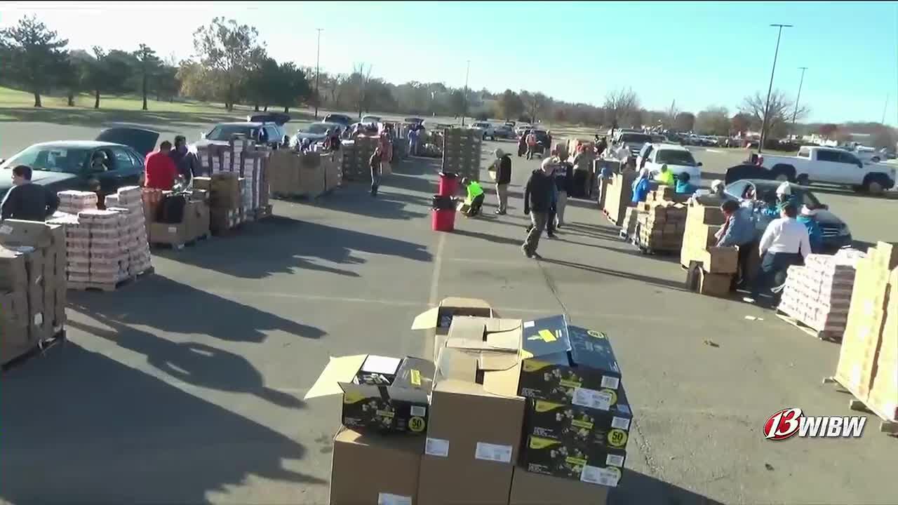 Hundreds line the parking lot for Harvesters’ food distribution Tuesday
