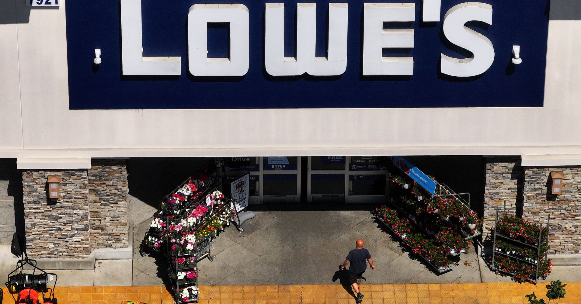 Lowe's beats on quarterly sales, but lowers full-year profit forecast ...