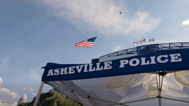 Asheville police drone unit displays giant American flag at Panthers game