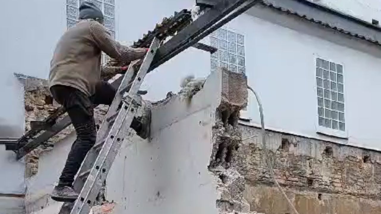 Demolition fail: Man conquers the wall but the door survives and stands ...