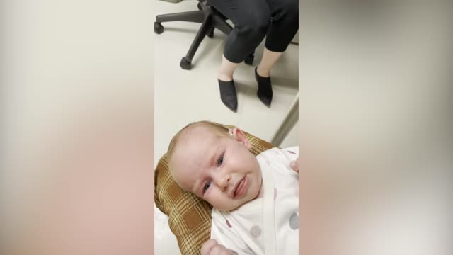 Baby joyfully giggles upon hearing her parents' voices for the first time