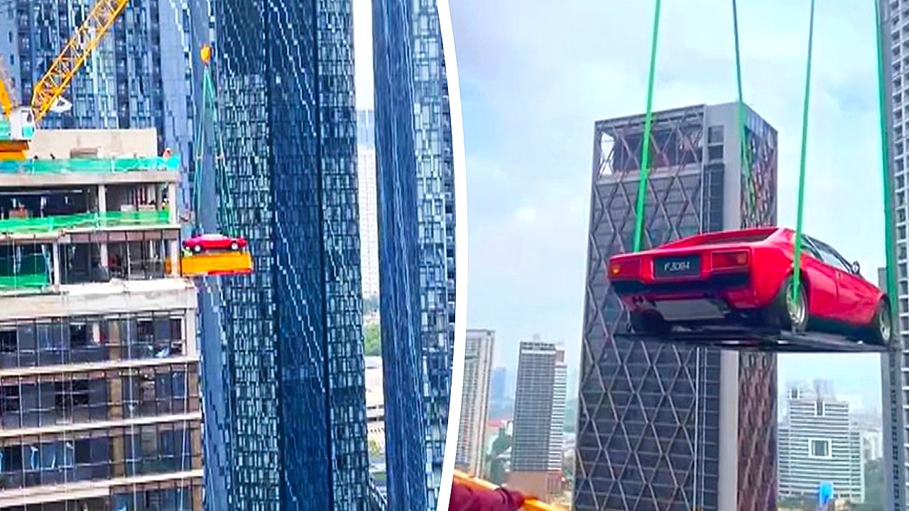 Locals baffled as vintage Ferrari hoisted into high-rise under construction