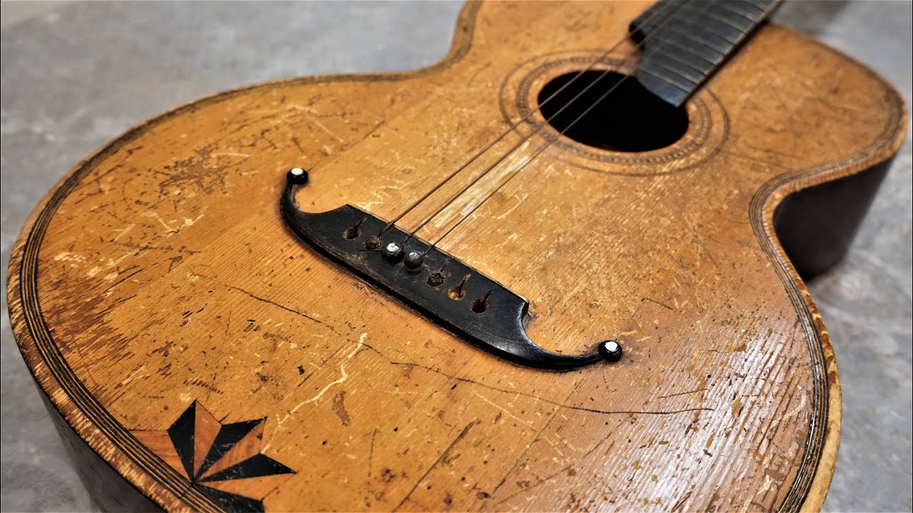 Watch how a furniture restorer restores a guitar