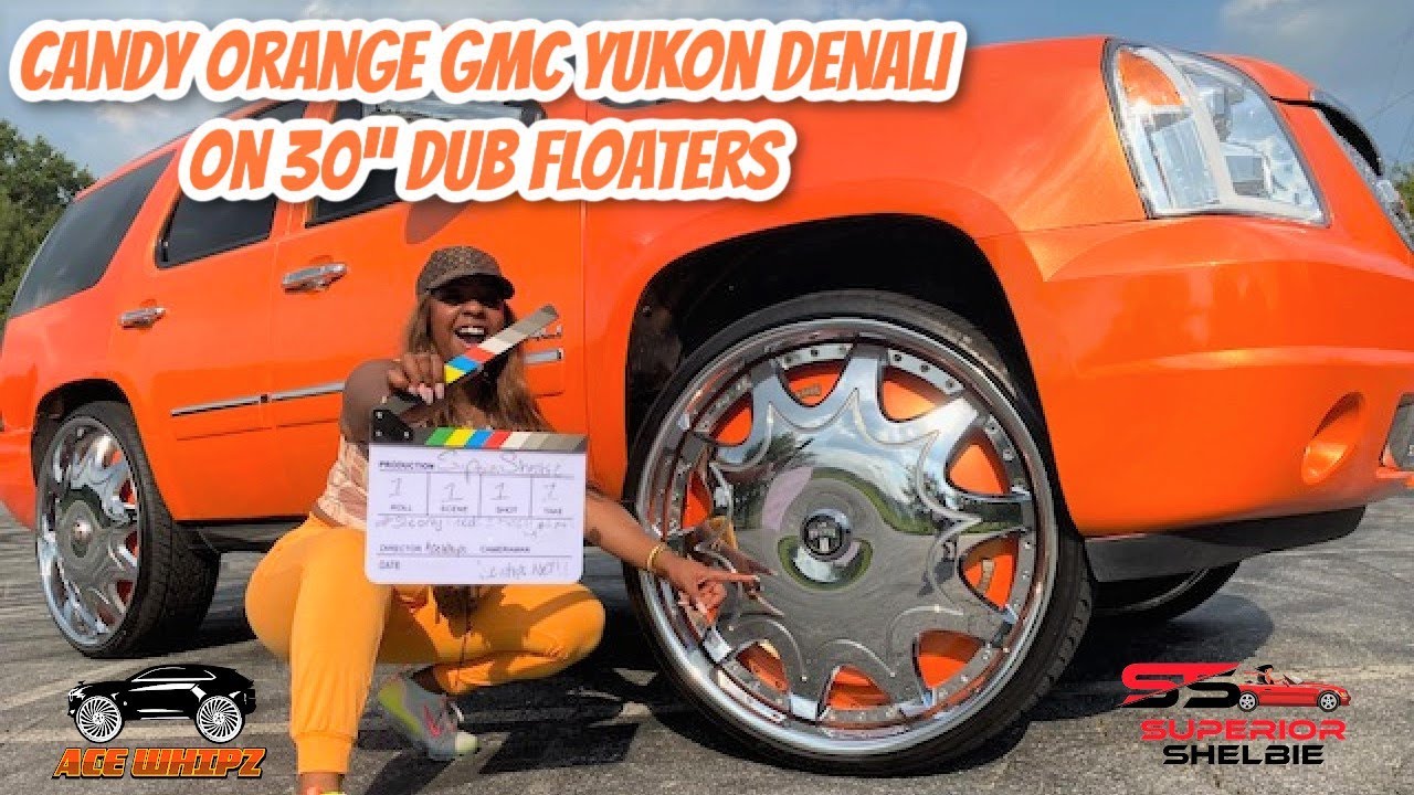Candy orange GMC Yukon Denali on 30” DUB floaters