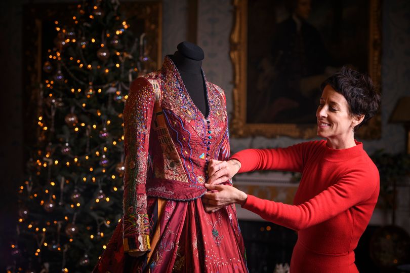 Stunning global dress embroidered by 380 people heads to Devon display
