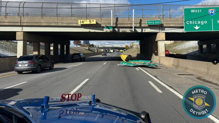 Garbage truck hits overpass sign on I-94 in Detroit