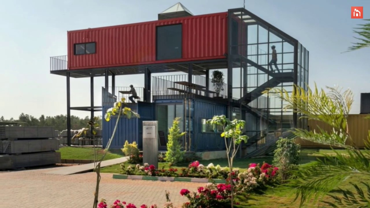 A colorful shipping container workspace on a concrete manufacturing site