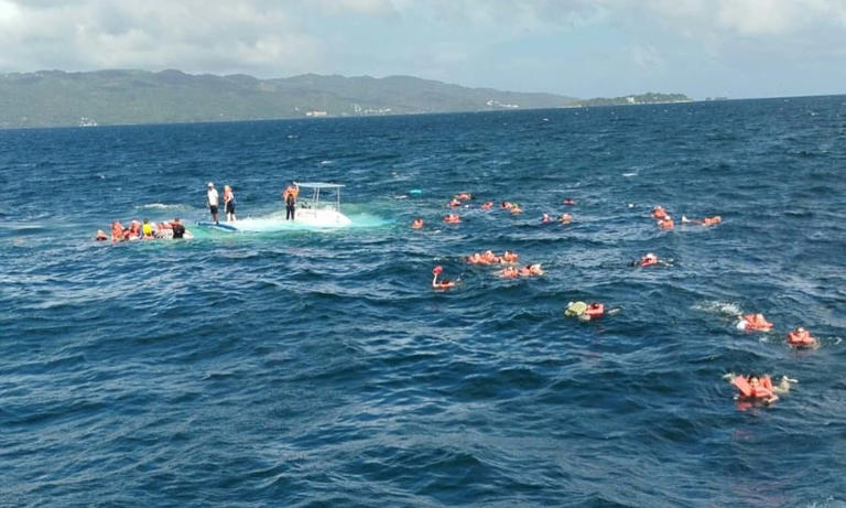 Moment cruise passengers are rescued from the sea after catamaran sinks ...