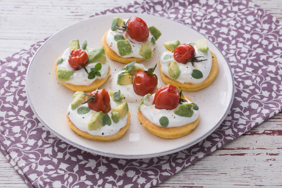 Corn blinis with skyr, avocado, and roasted cherry tomatoes
