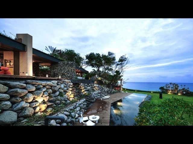 Tradition takes a modern turn: Terraced home with rock walls