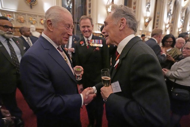 King hugs Second World War veteran, 105, at Windsor remembrance reception