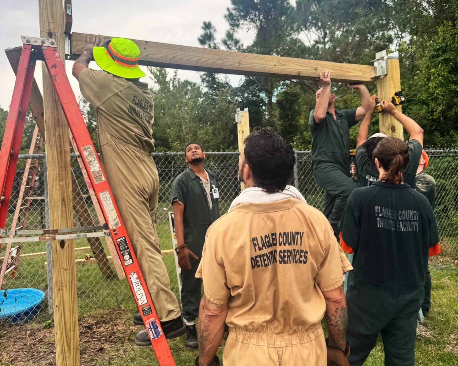 Male inmates in Flagler SMART program build four large dog shelters