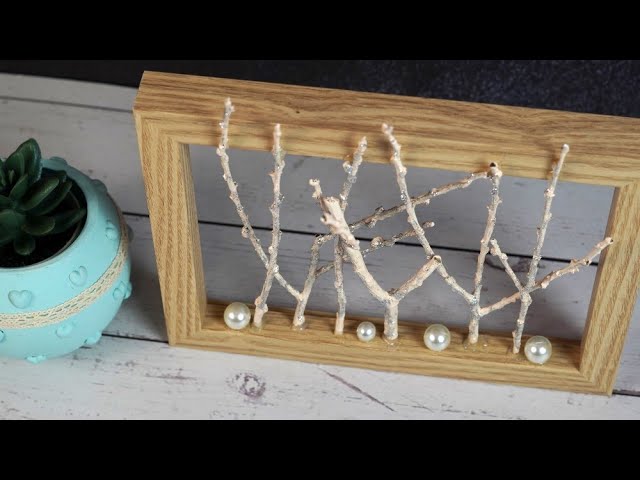 Old picture frame decorated with glittery twigs and pearls